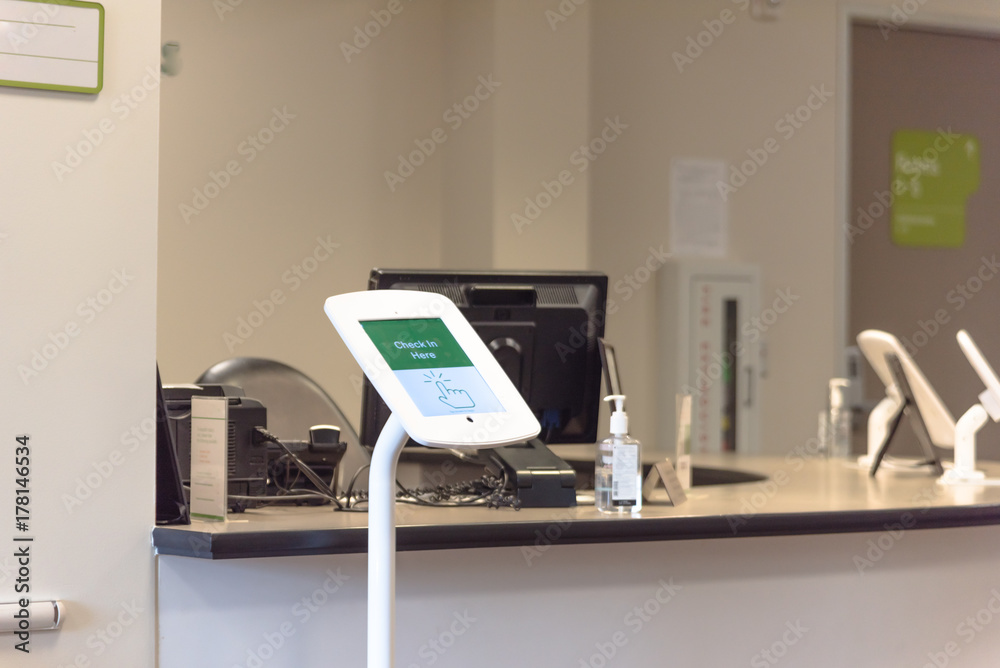 Check-in kiosk tablet upon arrival at front desk of test center for ...