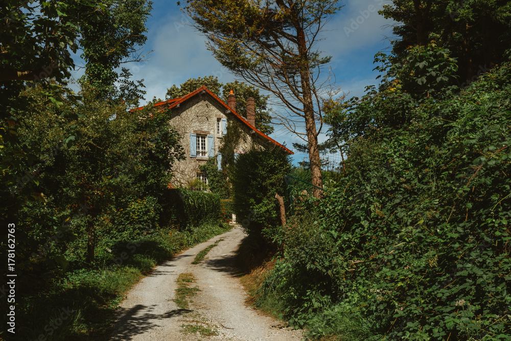 Old country house with blue shutters and gravel road in Normandy ...