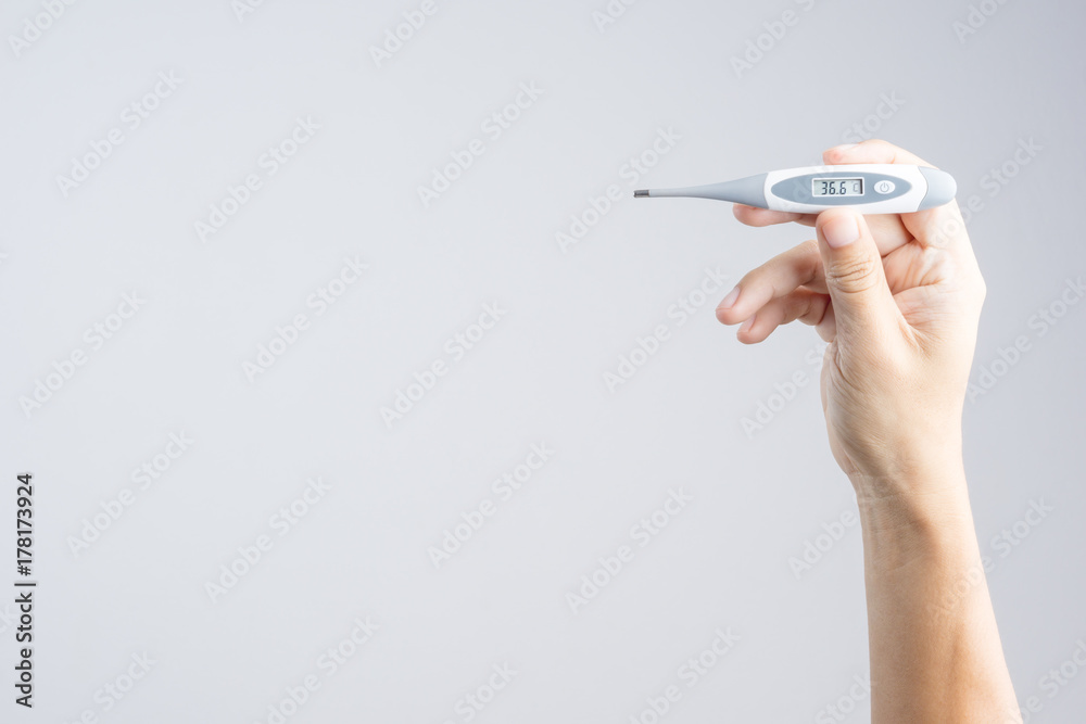 Hand holding electronic digital thermometer with healthy human body ...