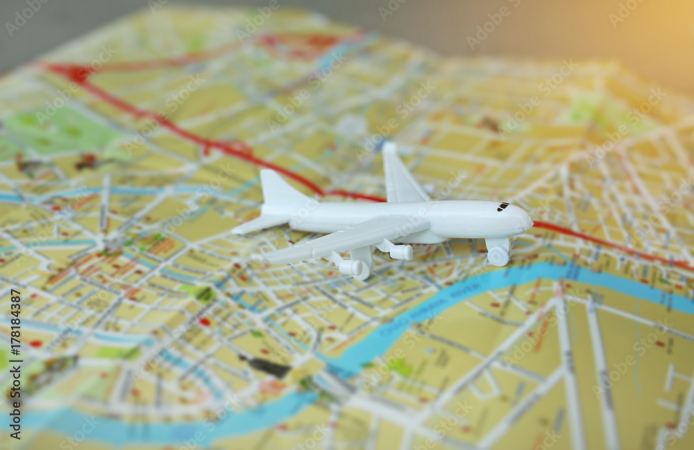 Miniature of a passenger plane flying on the map. Conceptual image for ...