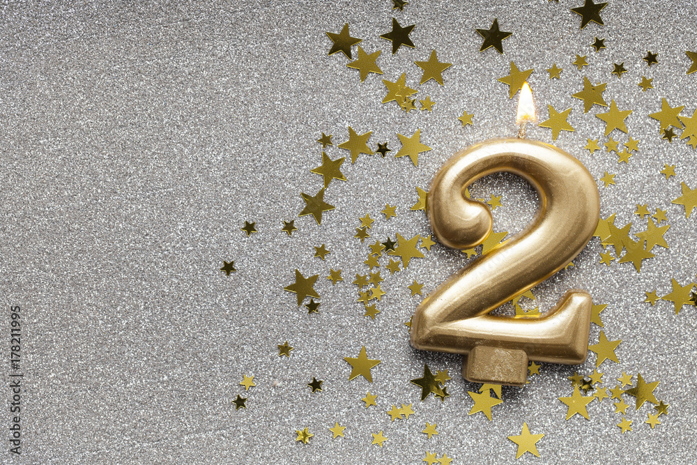 Number 2 gold celebration candle on star and glitter background Stock ...