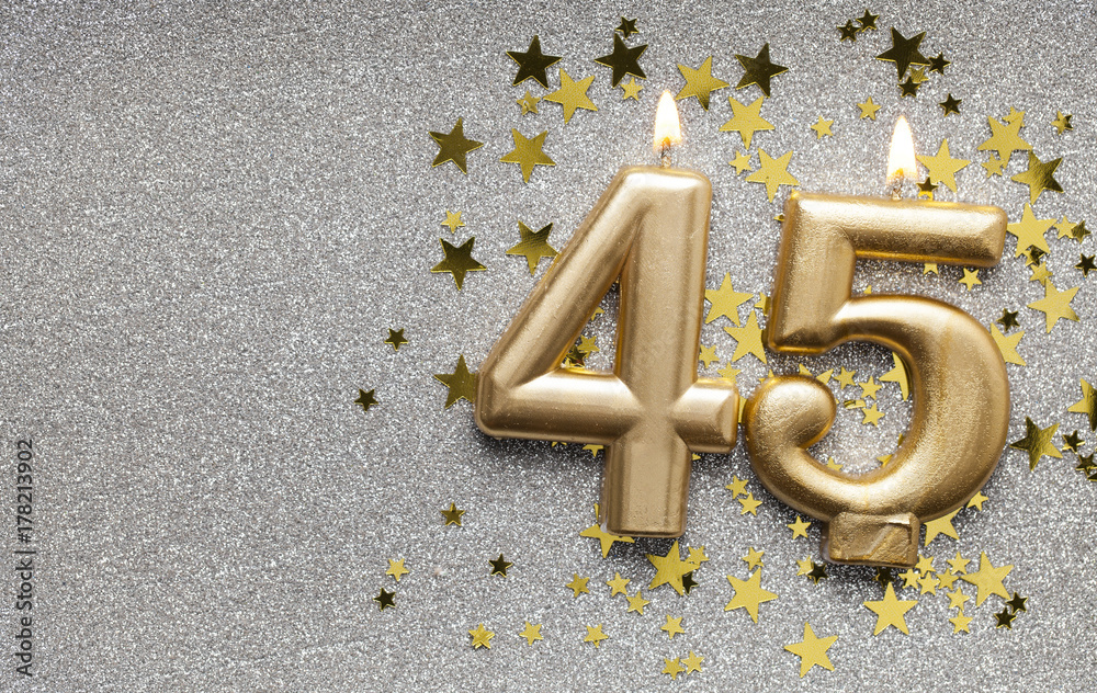 Number 45 gold celebration candle on star and glitter background Stock ...