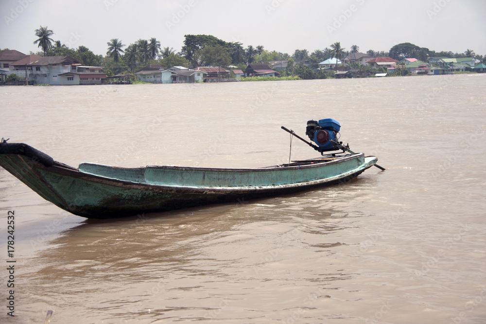 One wooden boat machine landing on the water in the river. it is a ...