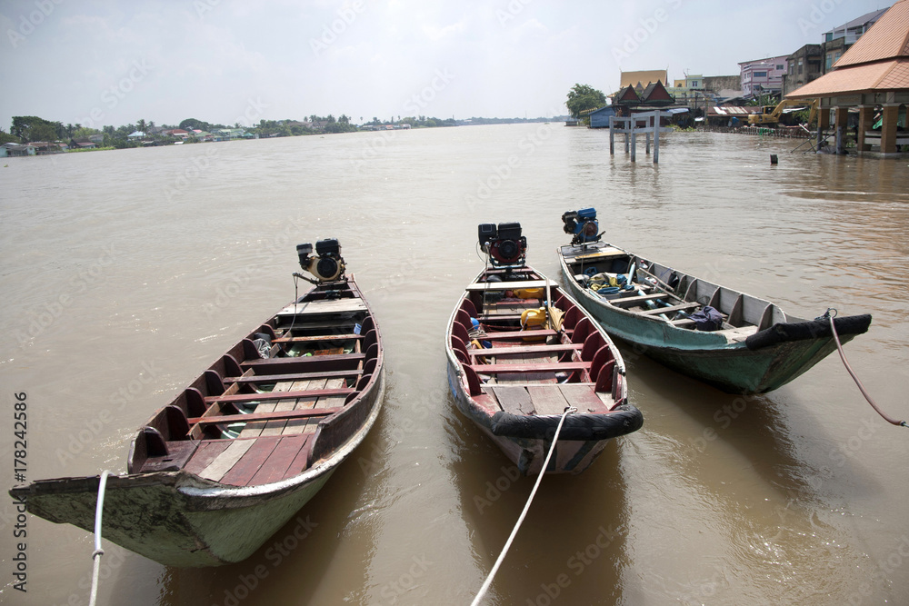 Three wooden boat machine landing on the water in the river. it is a ...