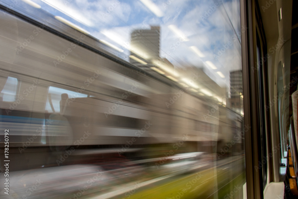 a view out from the window of a train. The industrial area is running ...
