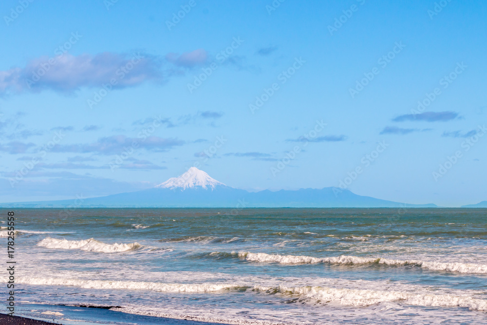 View on Mount Taranaki across Tasman sea at sunny day. Taranaki region ...