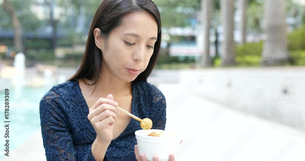 Woman eating fish ball in Hong Kong, famous local food Stock ビデオ ...