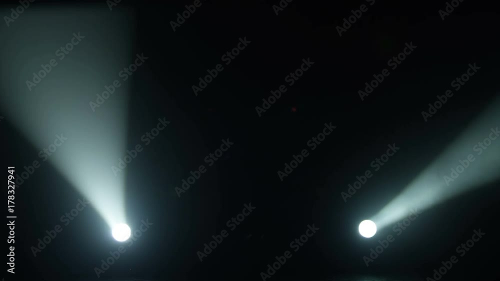 Realistic footage of stage light flashing rays spotlights through smoke ...