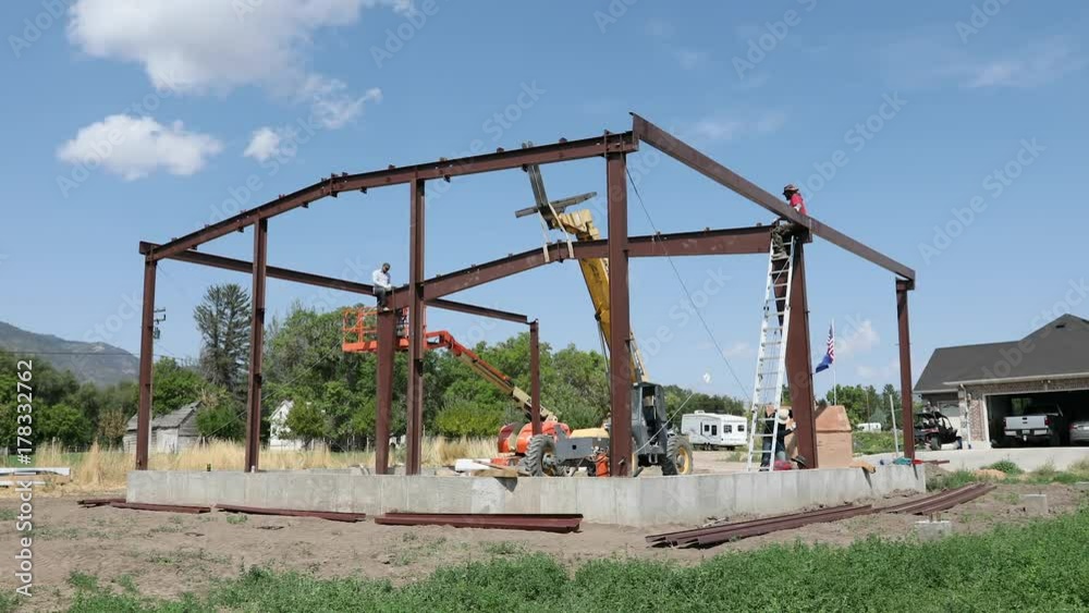 Rural farm building construction workers on steel beams. Construction ...