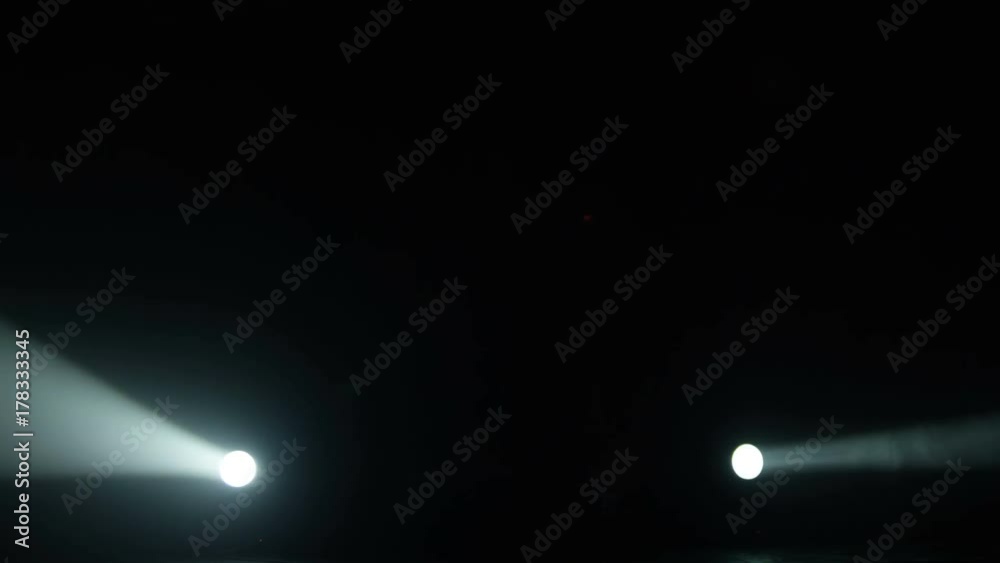 Realistic footage of stage light flashing rays spotlights through smoke ...