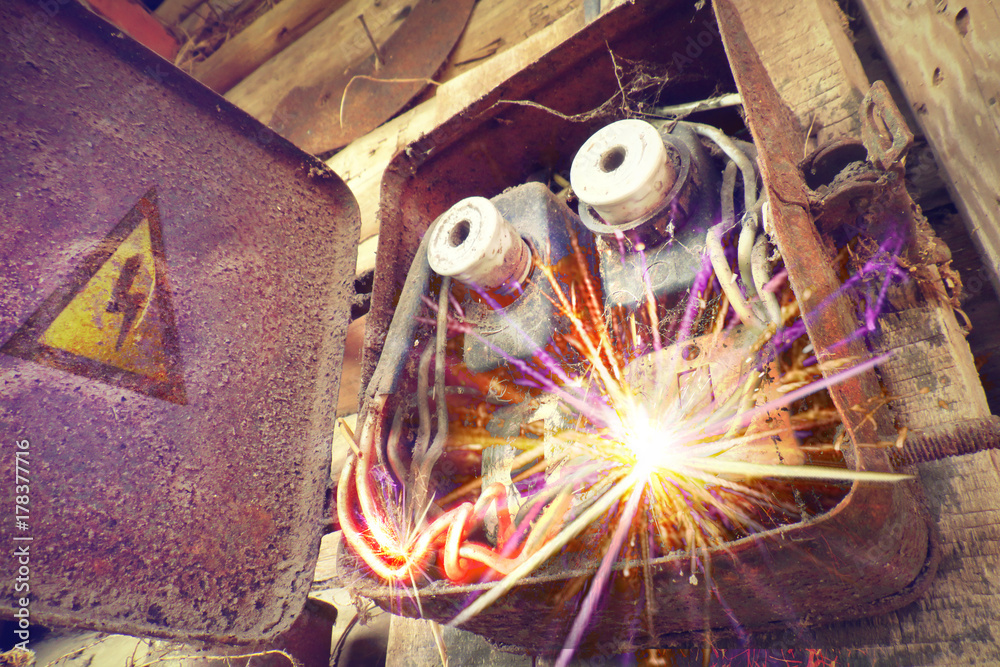 Rusty electric power supply boxes. Industrial background. Overloaded ...