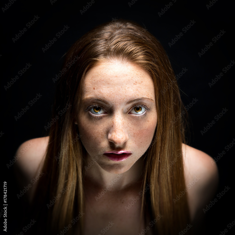 Beautiful young woman looks up to the camera. Stock Photo | Adobe Stock