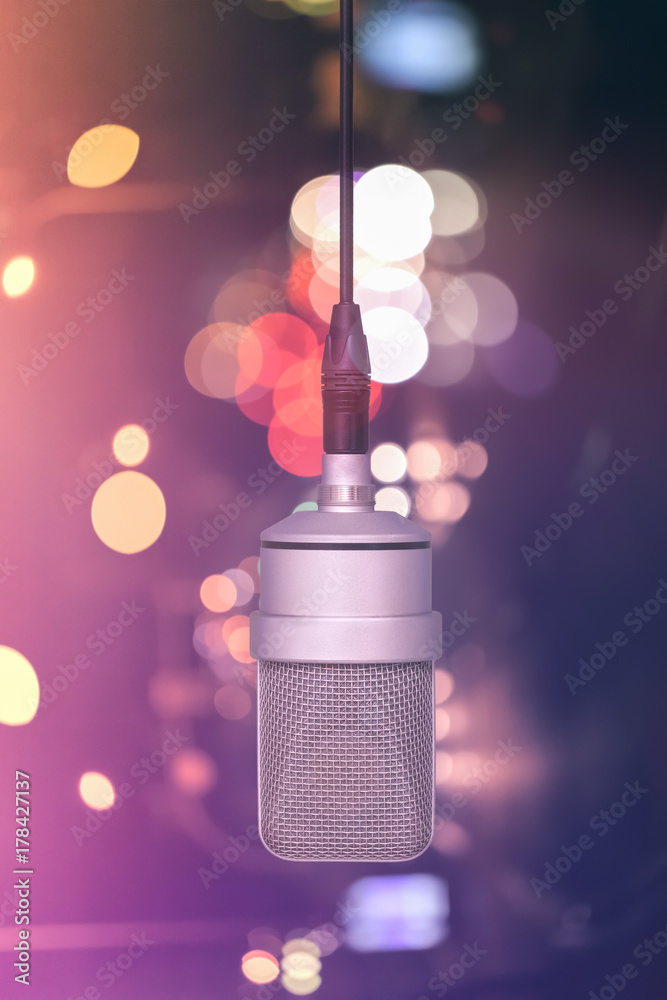 Professional microphone hanging on the cable, mic. Background defocused ...