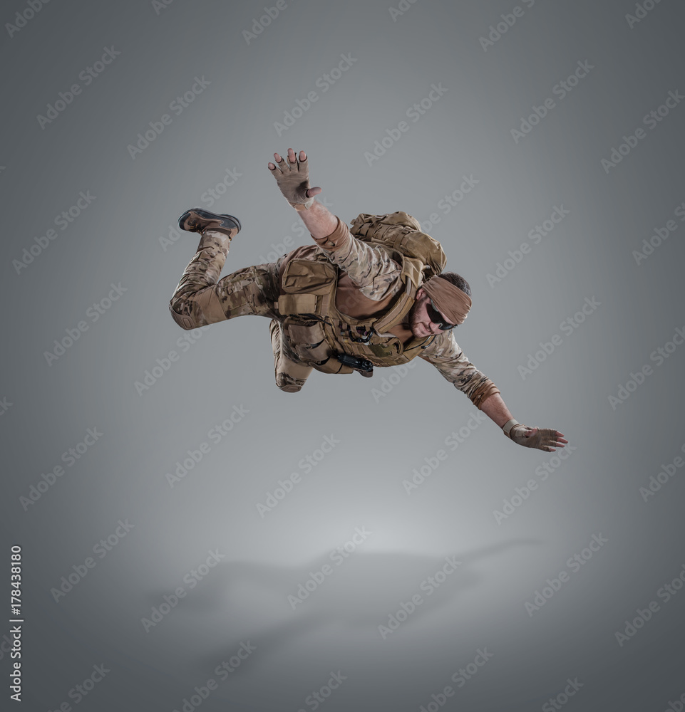 USA Army soldier with gun (motion effect). Shot in studio on gray ...