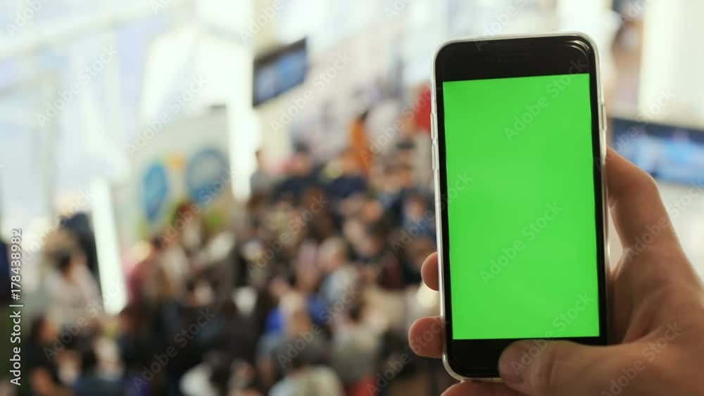 male man hand holding using smartphone typing swapping scrolling blank display mockup green ...