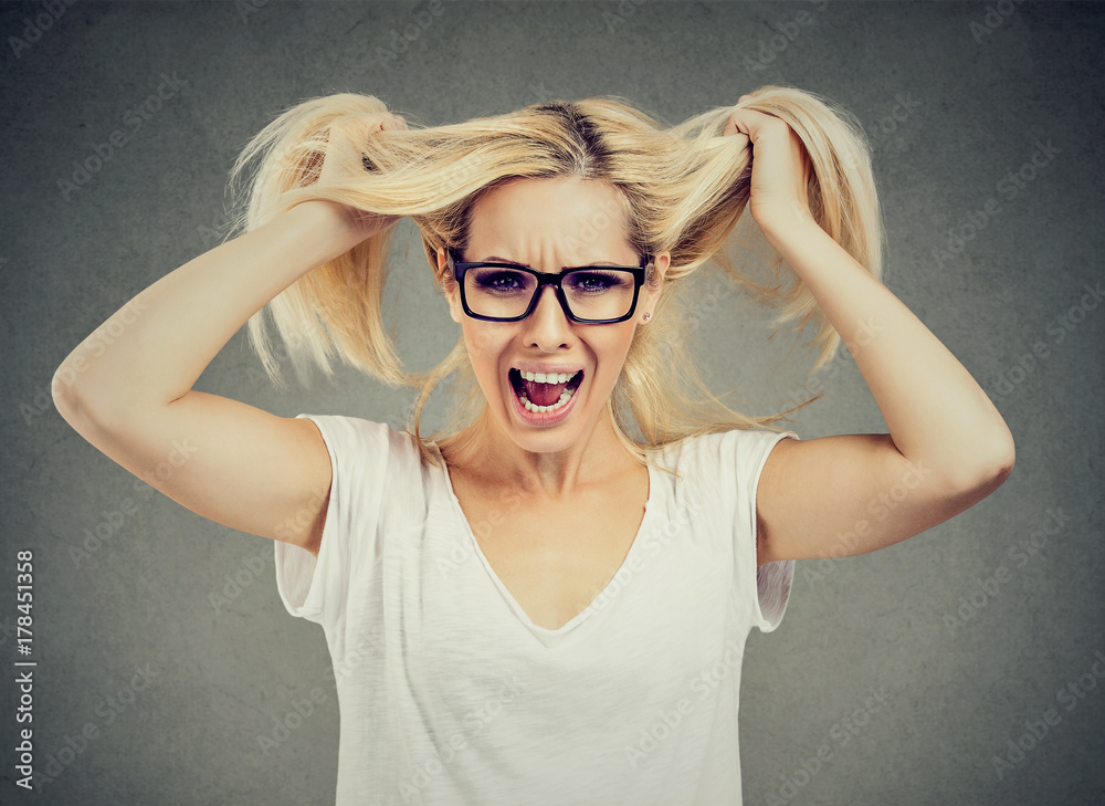 Angry woman screaming out loud and pulling her hair out Stock Photo ...