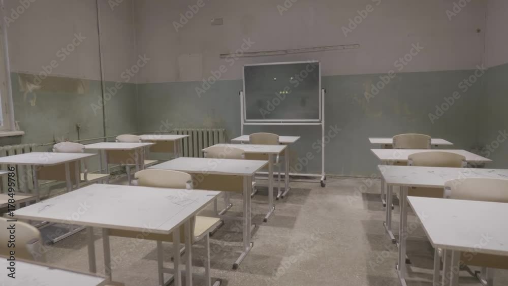 Empty classroom with wooden desks, white and green chalk boards in ...