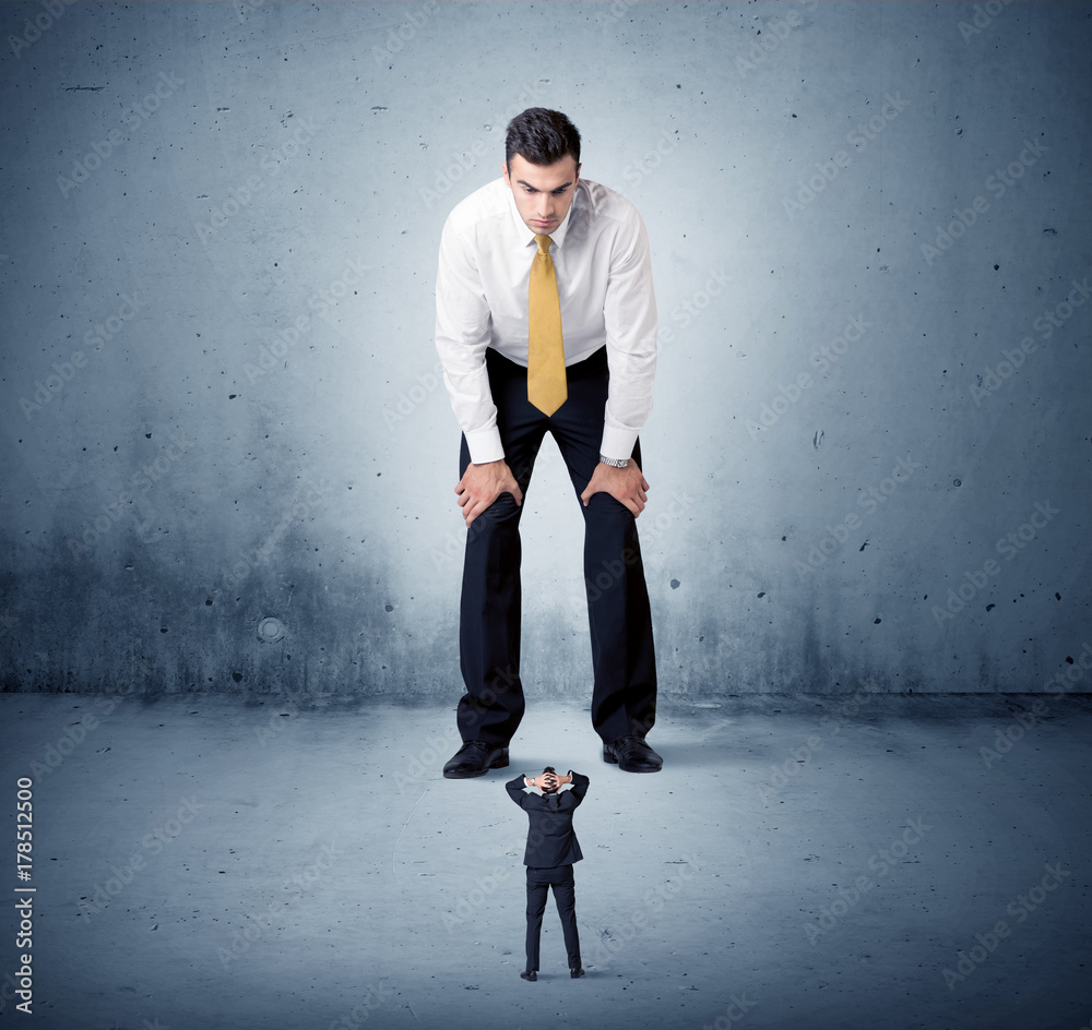 Angry huge business man lokking at small guy Stock Photo | Adobe Stock