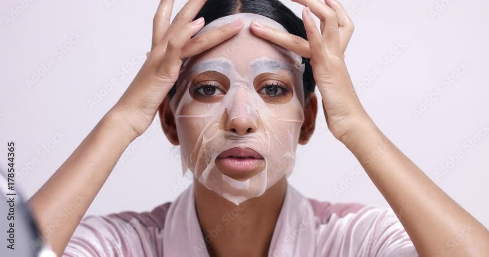 Attractive Middle Eastern woman with beautiful olive skin applying a ...