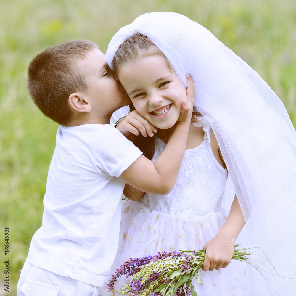 Young bride and groom playing wedding summer outdoor. Children like ...