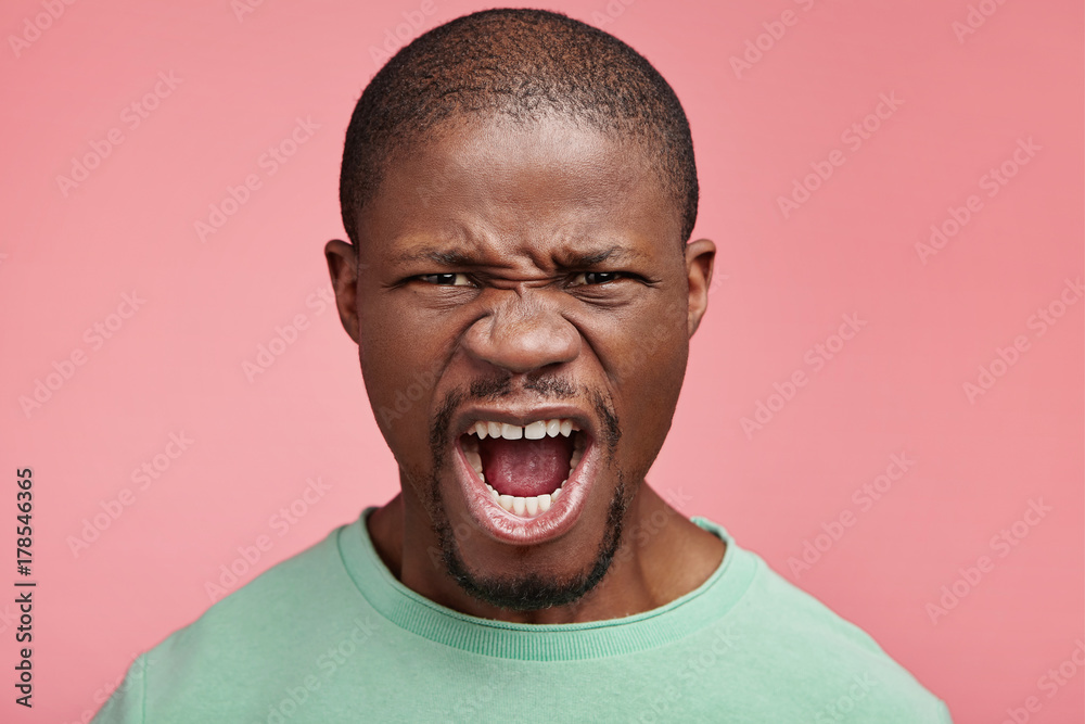 Horizontal portrait of outraged mad black young man being dissatisfied with his results and life ...