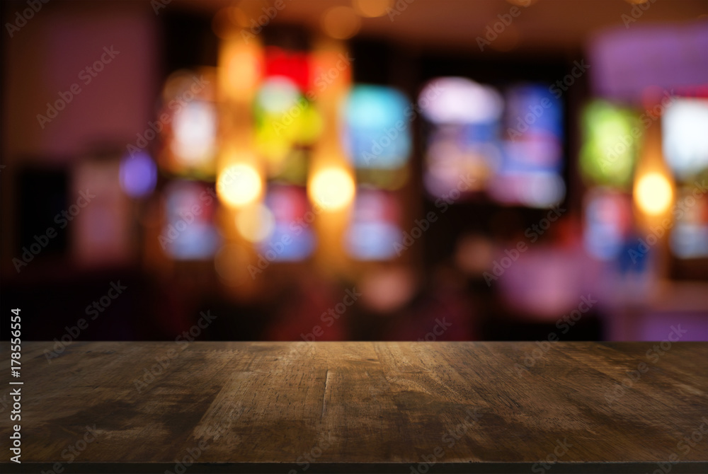 Empty dark wooden table in front of abstract blurred bokeh background ...