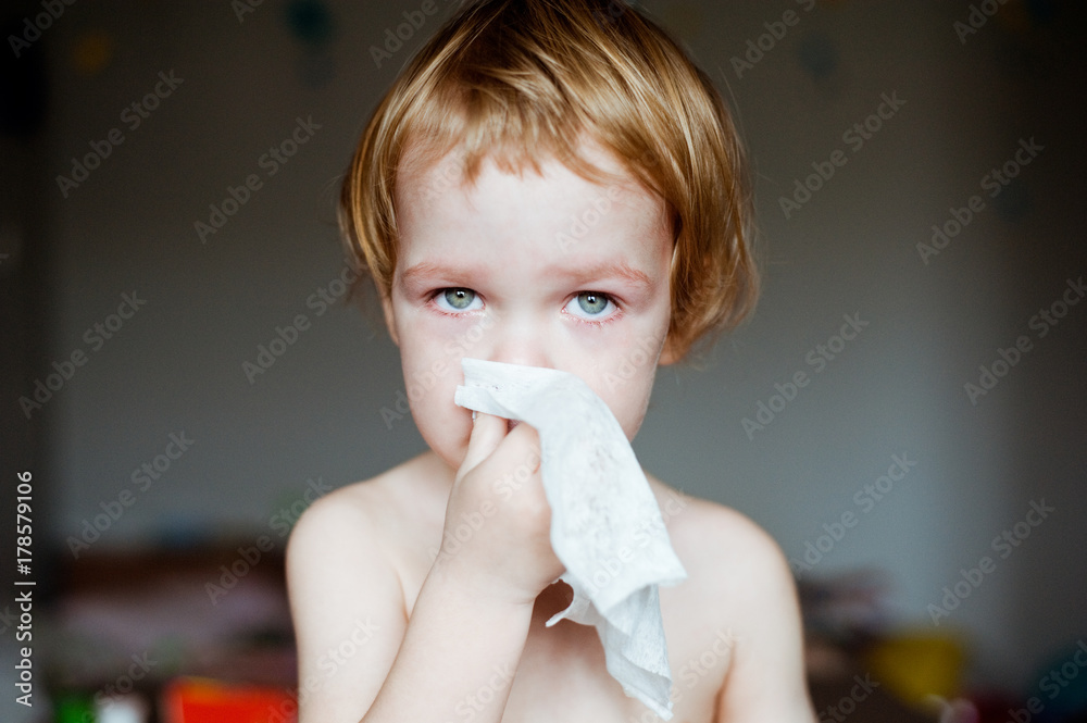 Cute little boy blowing his nose into a handkerchief. Stock Photo ...