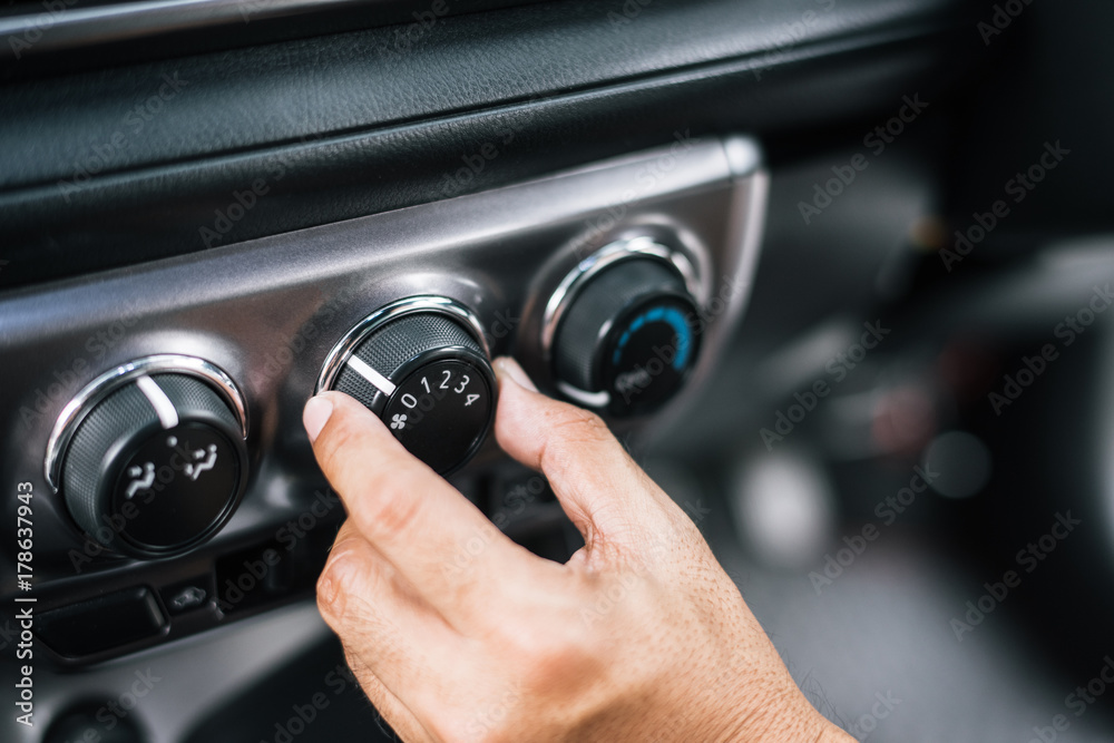 Hand of man turning on car air conditioning system,finger hitting car ...