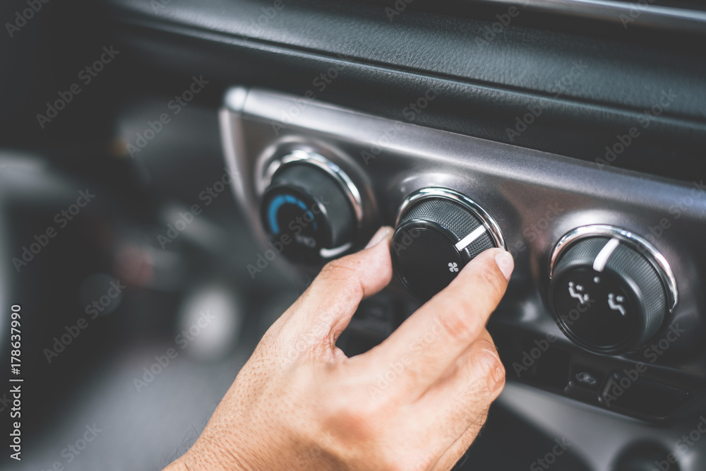 Hand of man turning on car air conditioning system,finger hitting car ...