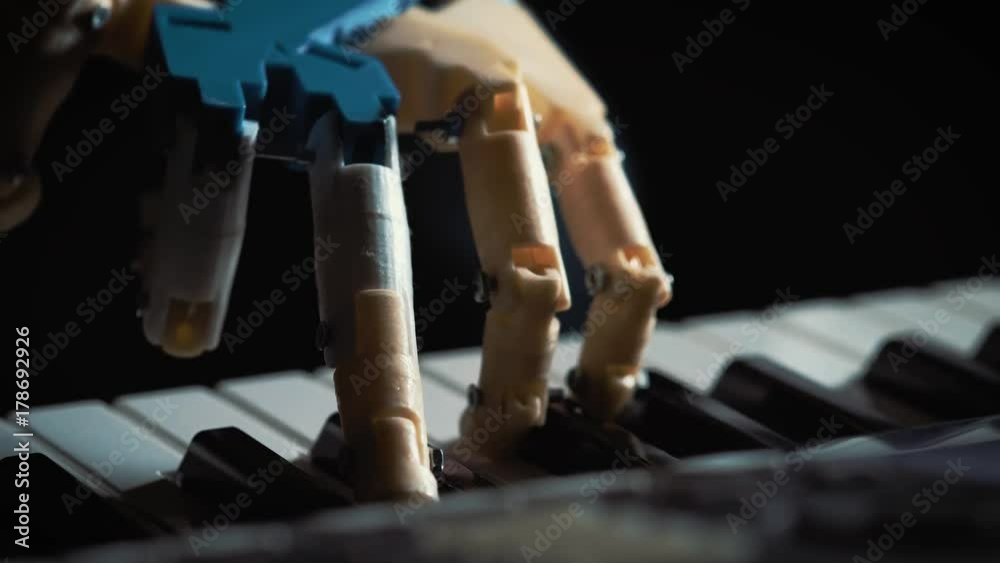 man musician pianist with a prosthetic hand playing the piano. He plays ...