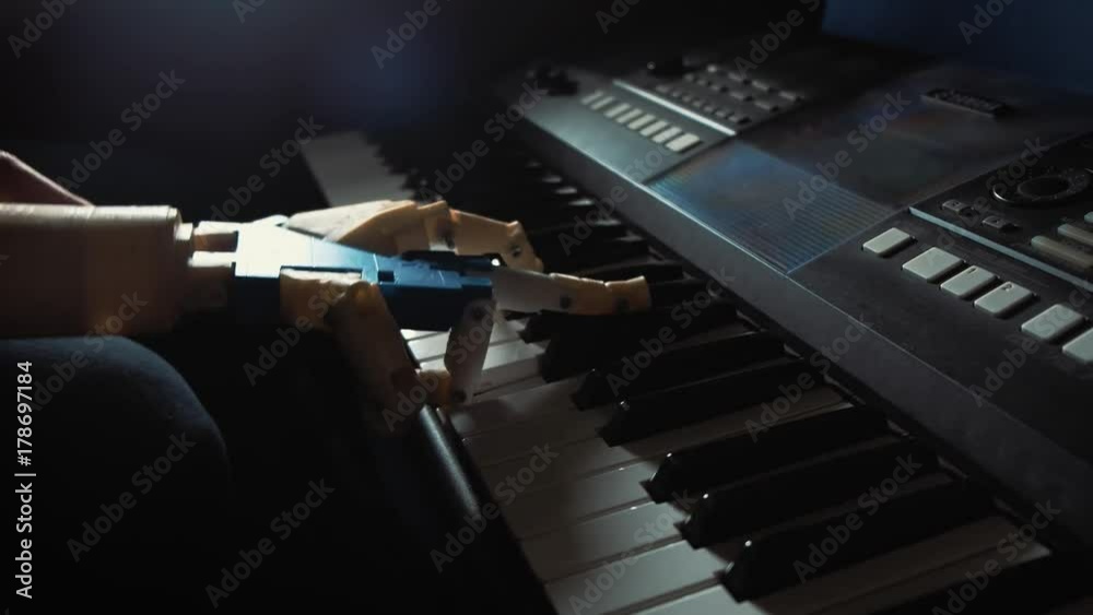 Robot plays a musical instrument. man musician pianist with a ...