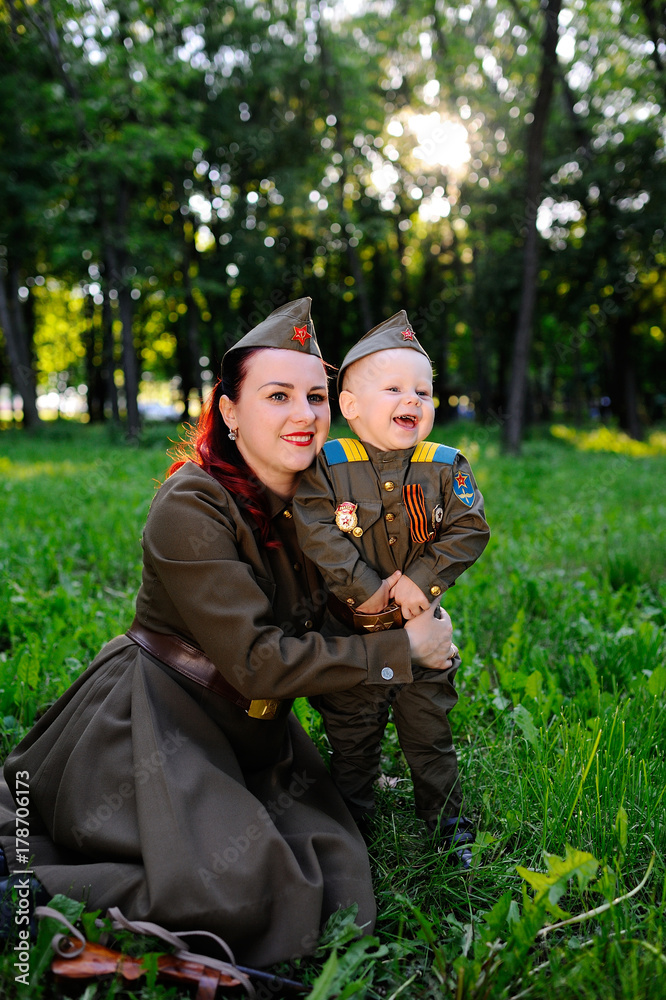 Mom and son in a military Soviet soldier uniform with St. George ...