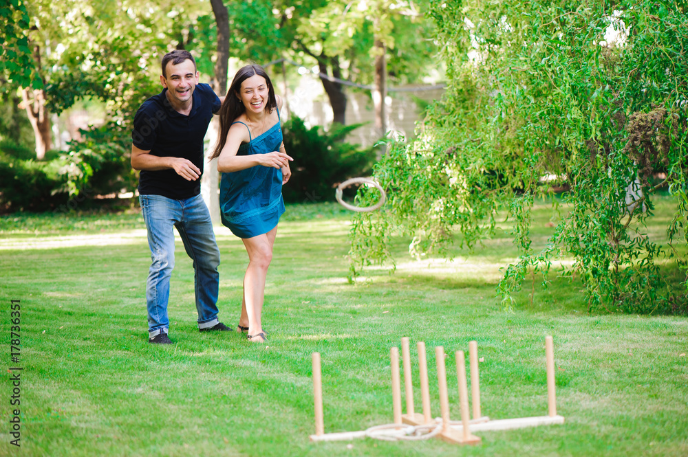 Friends plaing outdoor games - ring toss. Stock Photo | Adobe Stock