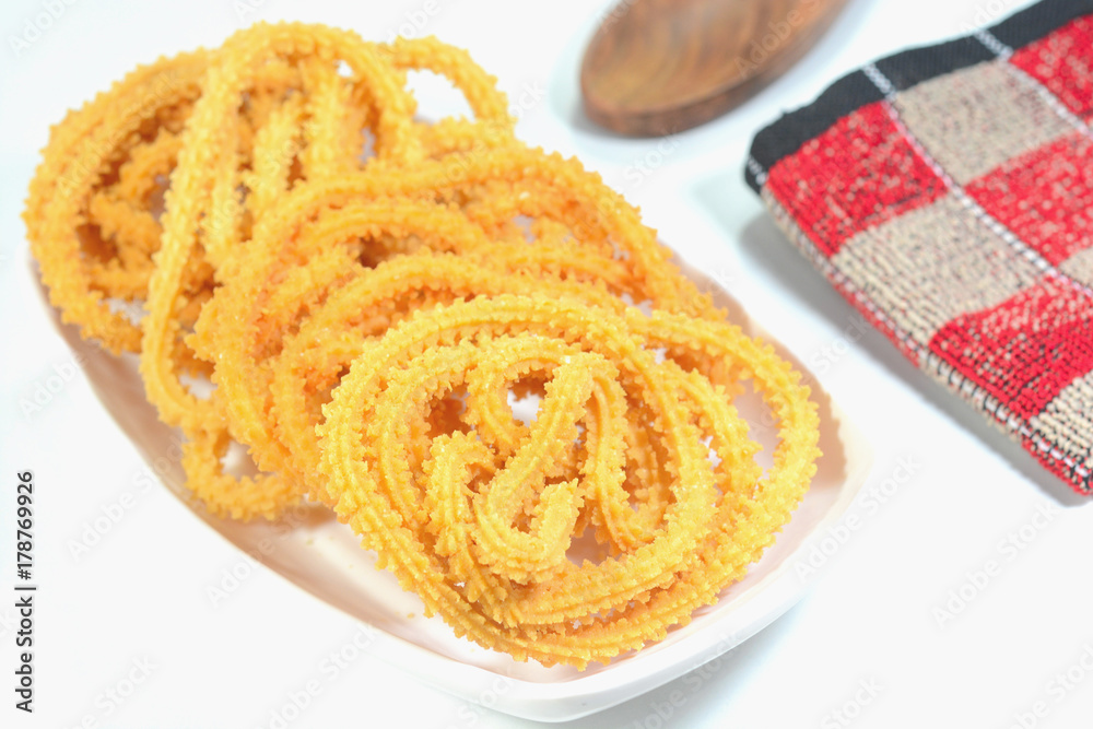 Indian savoury dish Murukku is spicy and crunchy dish prepared in South ...