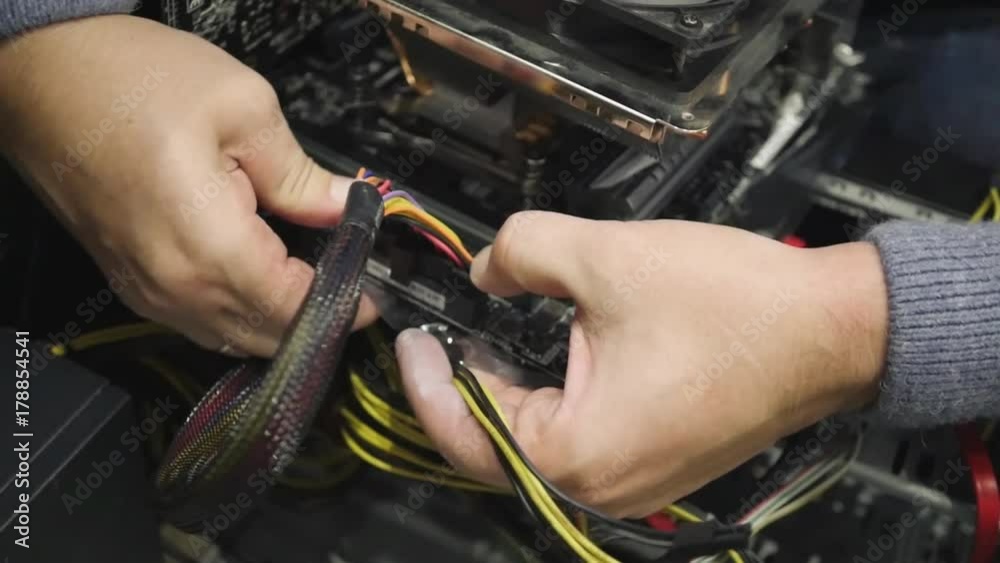The man collects the system unit and many wires. HD, 1920x1080. slow ...