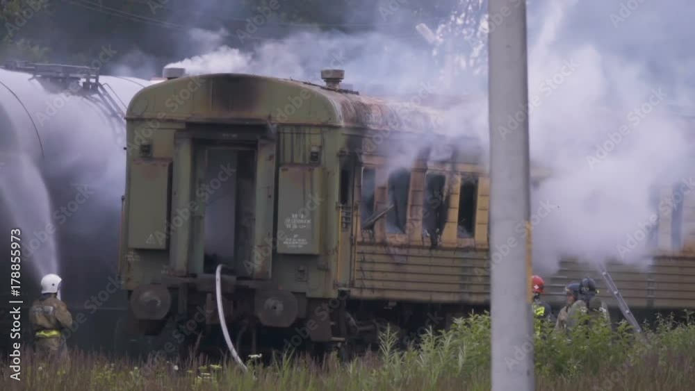 Fire at railway station. Firefighters extinguish railway car. Fire in a ...