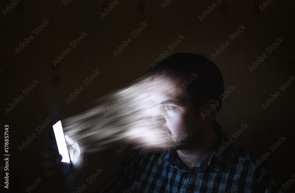 Concept Internet of dependence, submission. Man sucked into a phone ...