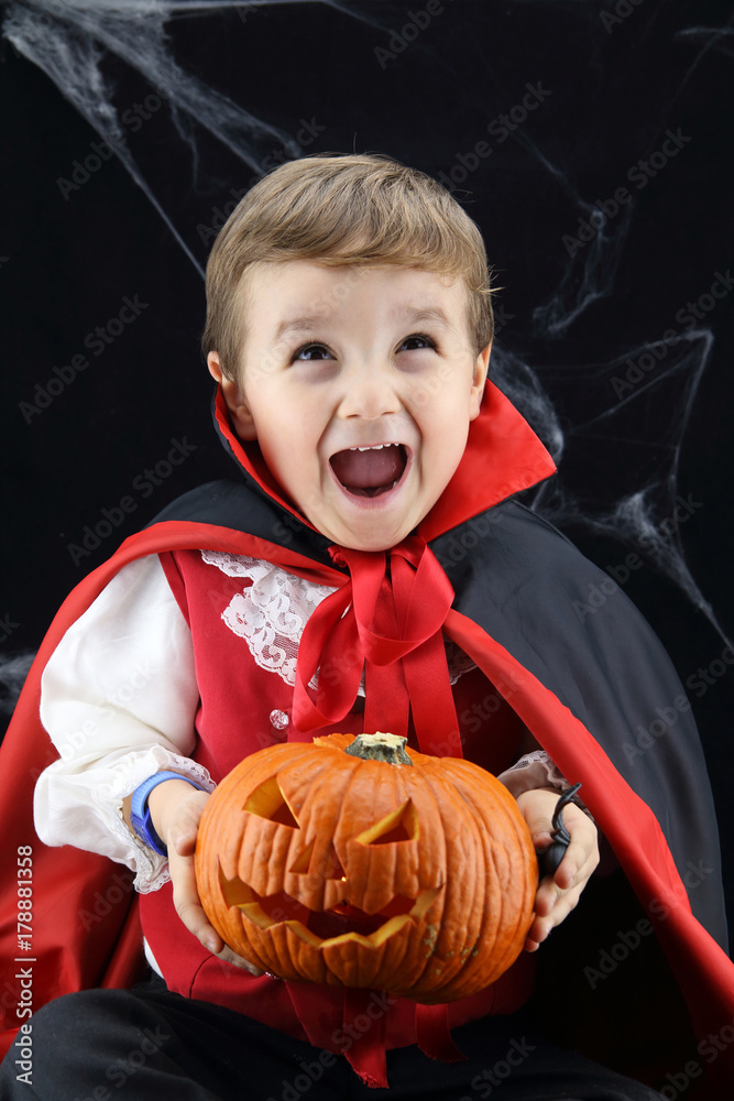 surprised child with vampire costume in a black background Stock Photo ...