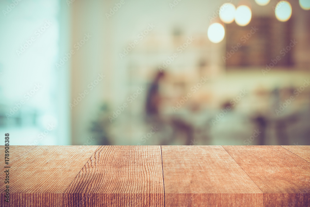 empty wooden pallet table and blurred cafe or coffee shop, vintage tone ...