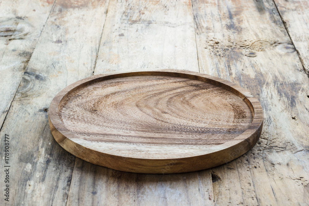 Empty wooden plate on wood table. Copy space. Wood plate for food or ...