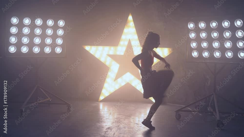 A young professional dancer performs a fast number on stage in the ...