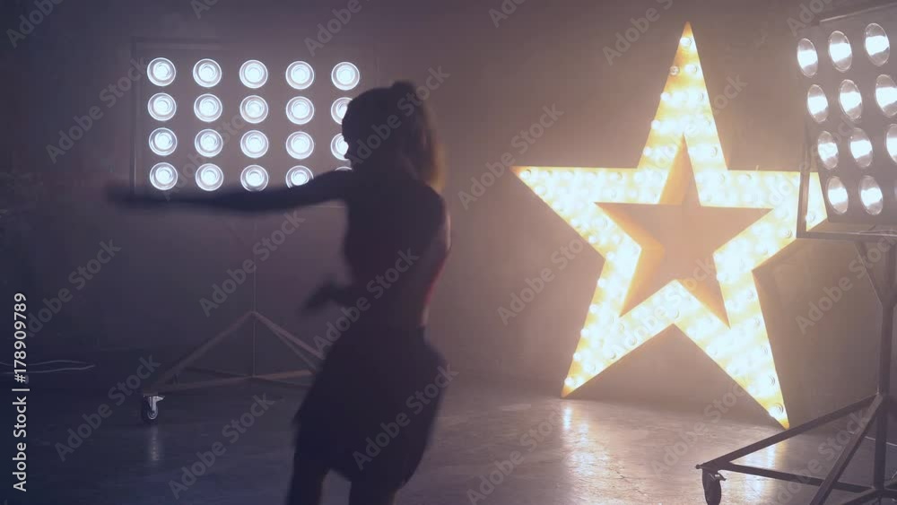 A young professional dancer performs a fast number on stage in the ...