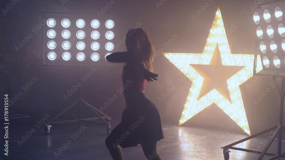 A young professional dancer performs a fast number on stage in the ...