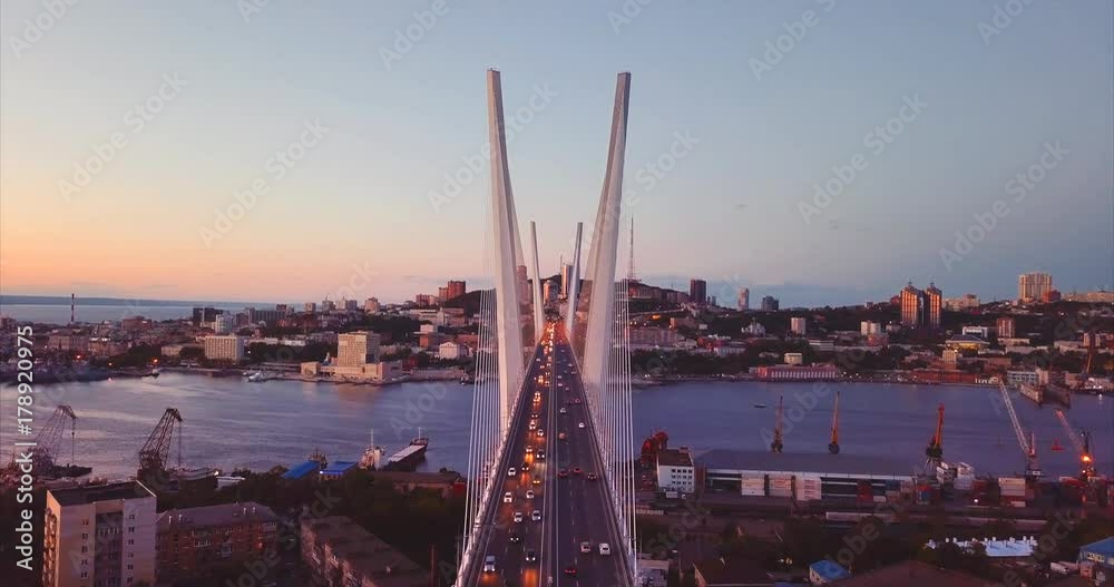Slowly flying above the Golden Bridge (built in 2012) with cars driving ...