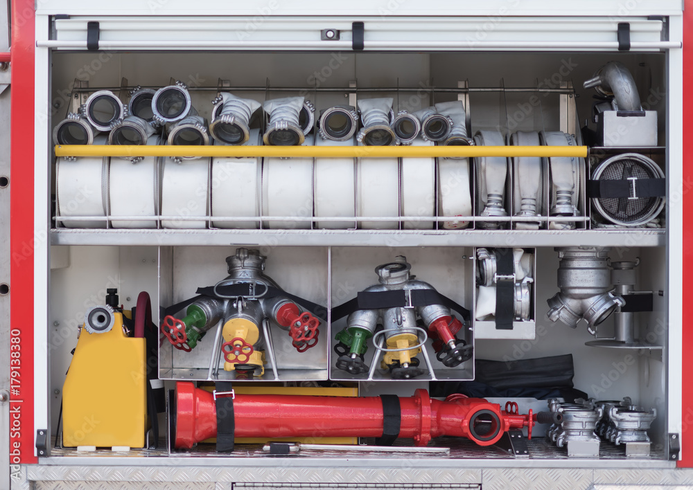 Compartment of rolled up fire hoses on a fire engine. Rescue fire truck ...