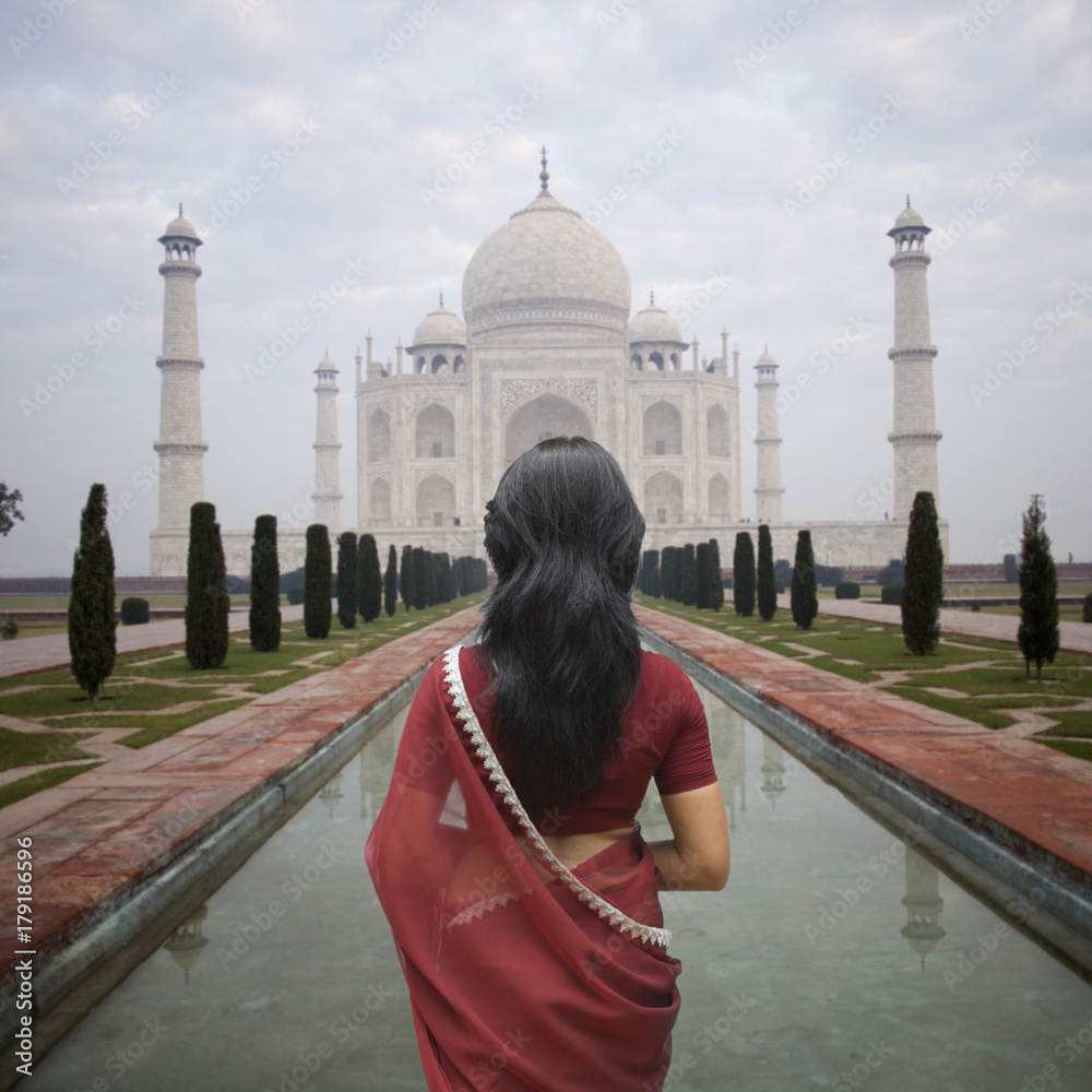 Indian woman standing in front of Taj Mahal. India. Stock Photo | Adobe ...