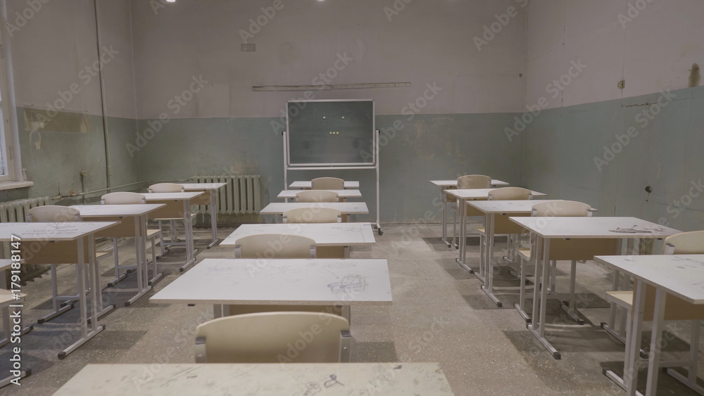 Empty classroom with wooden desks, white and green chalk boards in ...
