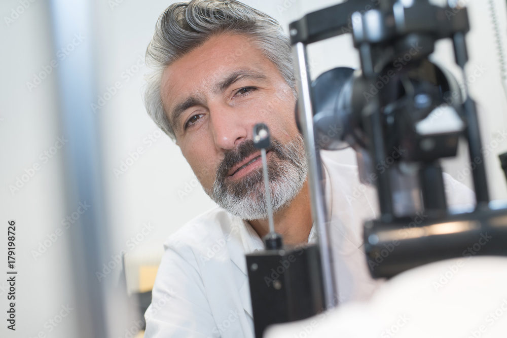 optometrist doing sight testing for patient Stock Photo | Adobe Stock
