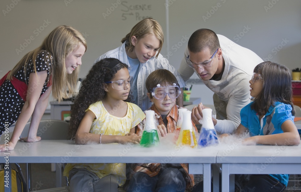 Children (10-11) and teacher at science class Stock Photo | Adobe Stock