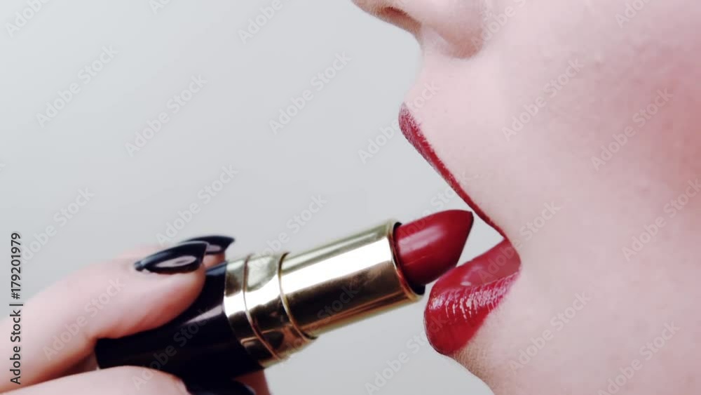 Close-up female lips with red lipstick.Side view. In studio on white ...